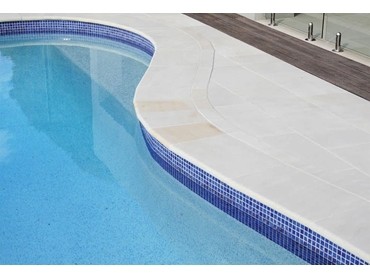 Mint White honed sandstone from Cinajus provides smooth pool surround ...