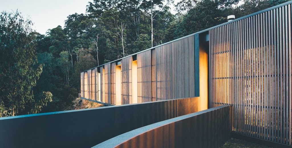 Glass home wrapped in sliding timber screens offers views and sun ...